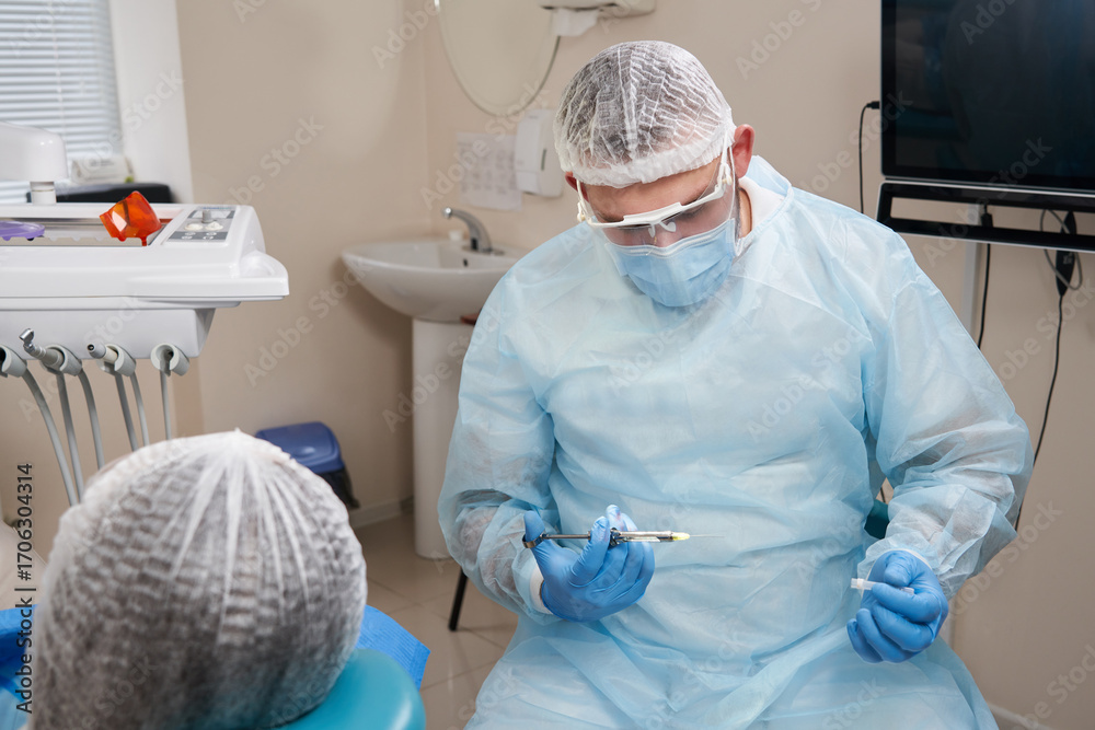 Dentist making local anesthesia shot before surgery. Patient visiting a ...