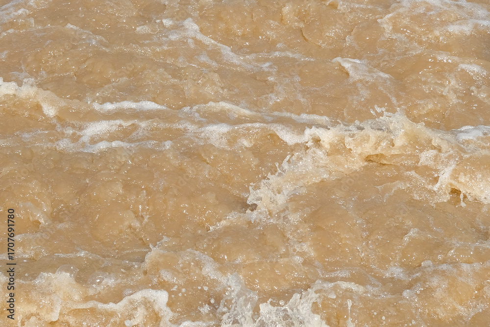Background texture of a murky brown and foamy river flow. Ecological ...