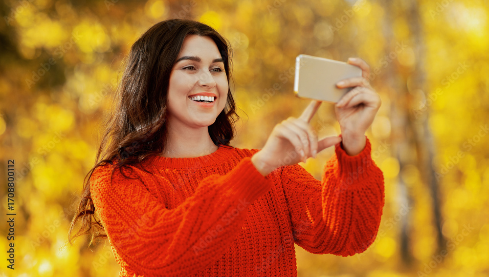 Pretty young lady taking picture of beautiful autumn nature on ...