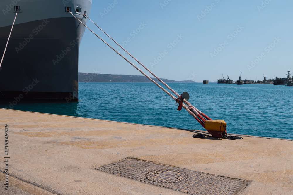 Mooring of a vessel in the port using mooring lines to a bollard on the ...