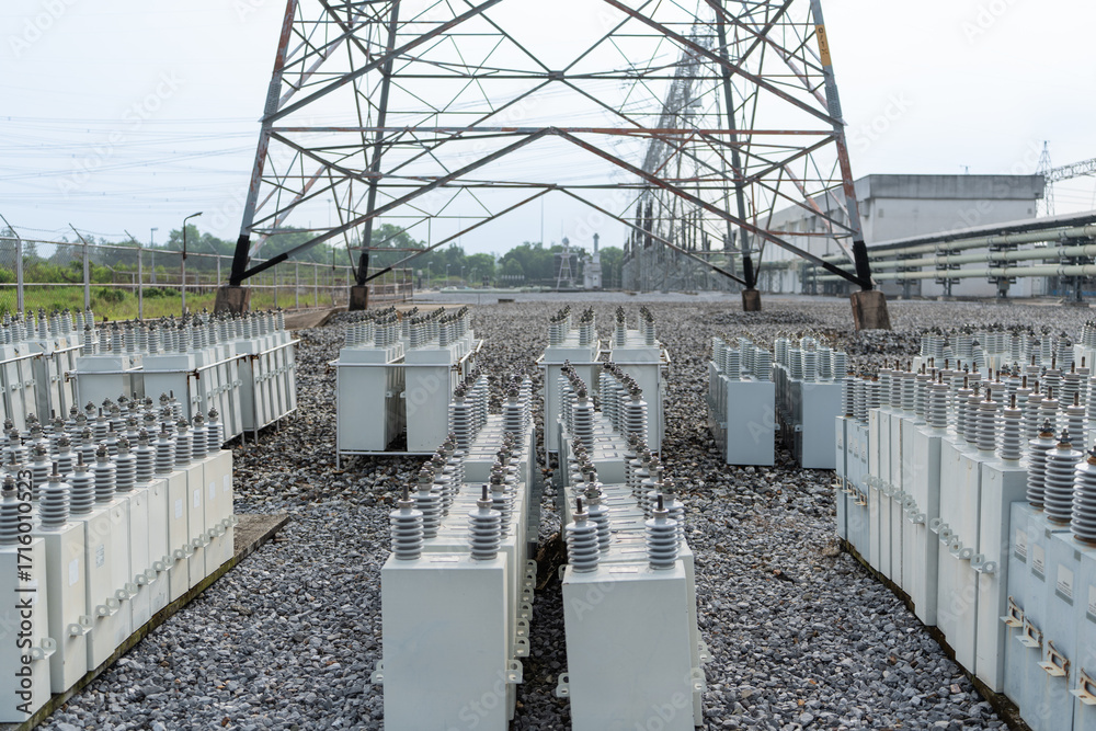 Stock-Foto „Capacitor banks aligned in rows under steel transmission ...