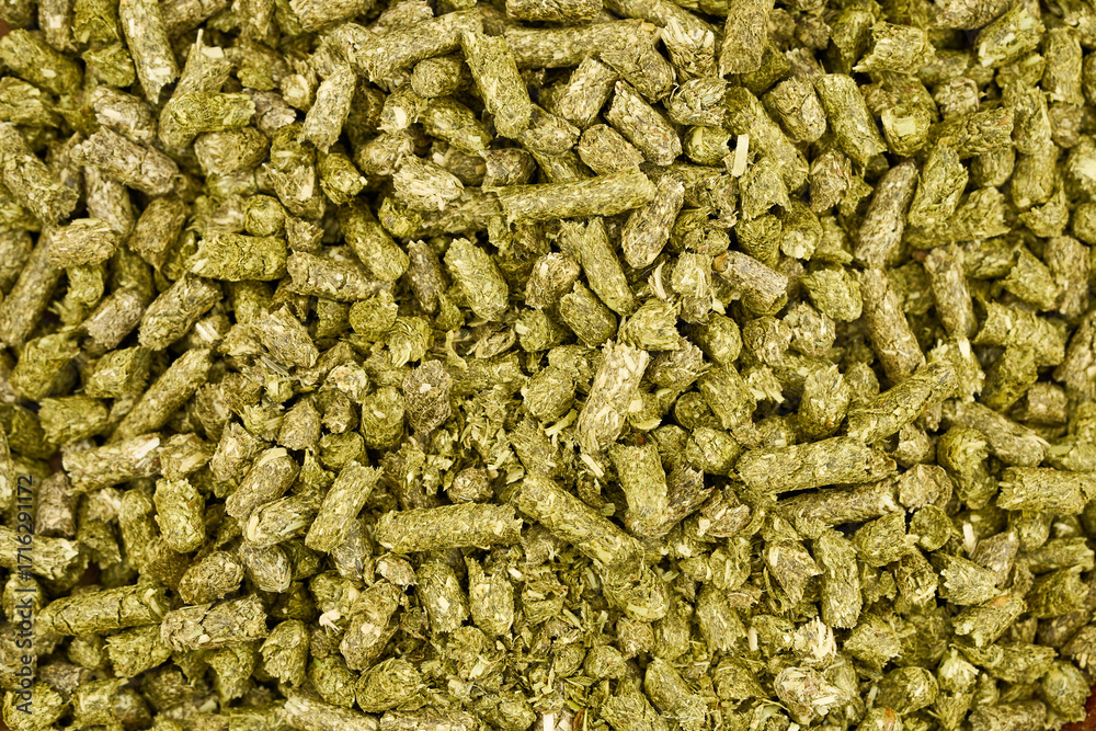 flat lay pile of green timothy grass pellet for rodent pet food feed ...