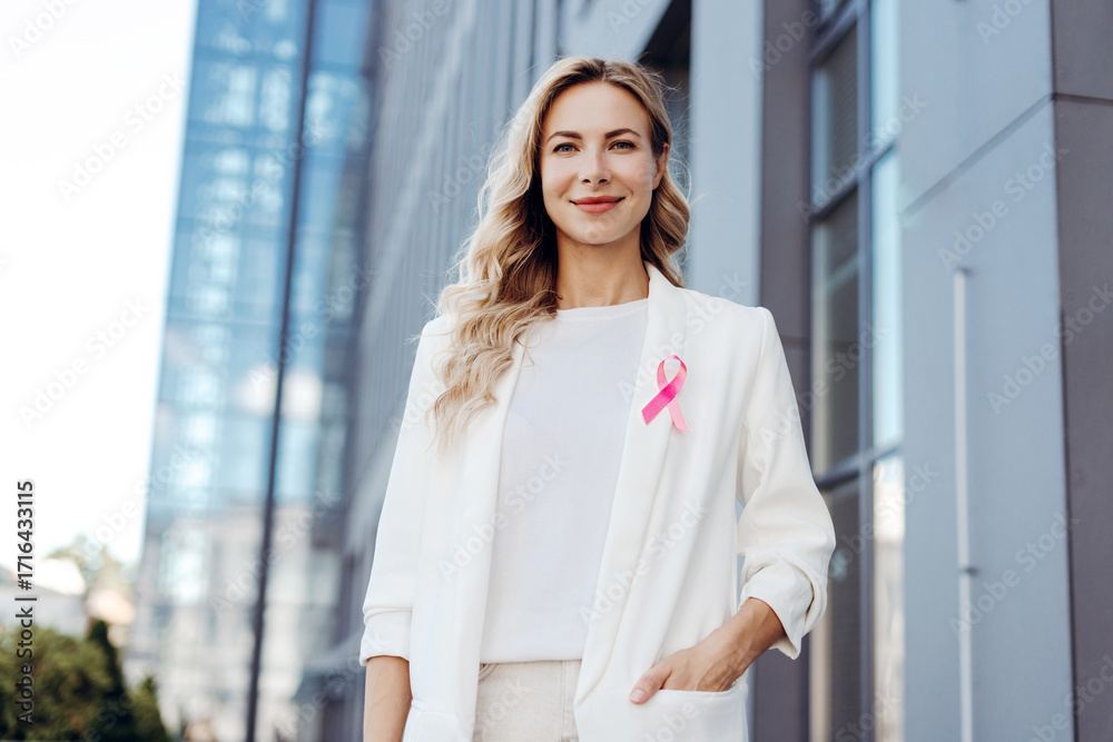 Стоковое фото «Woman wearing pink ribbon supporting breast cancer ...