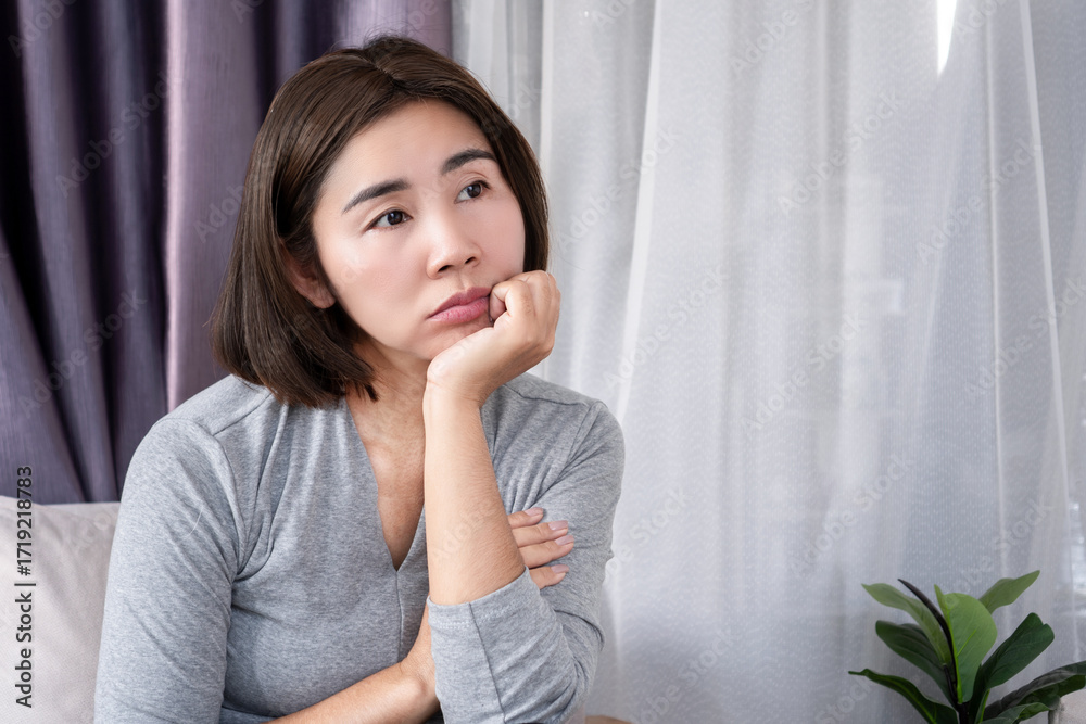 Sad Asian woman staying alone at home, feeling anxious, depressed, and ...