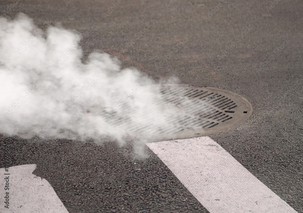 white smoke coming out of an asphalt manhole like steam from subway ...