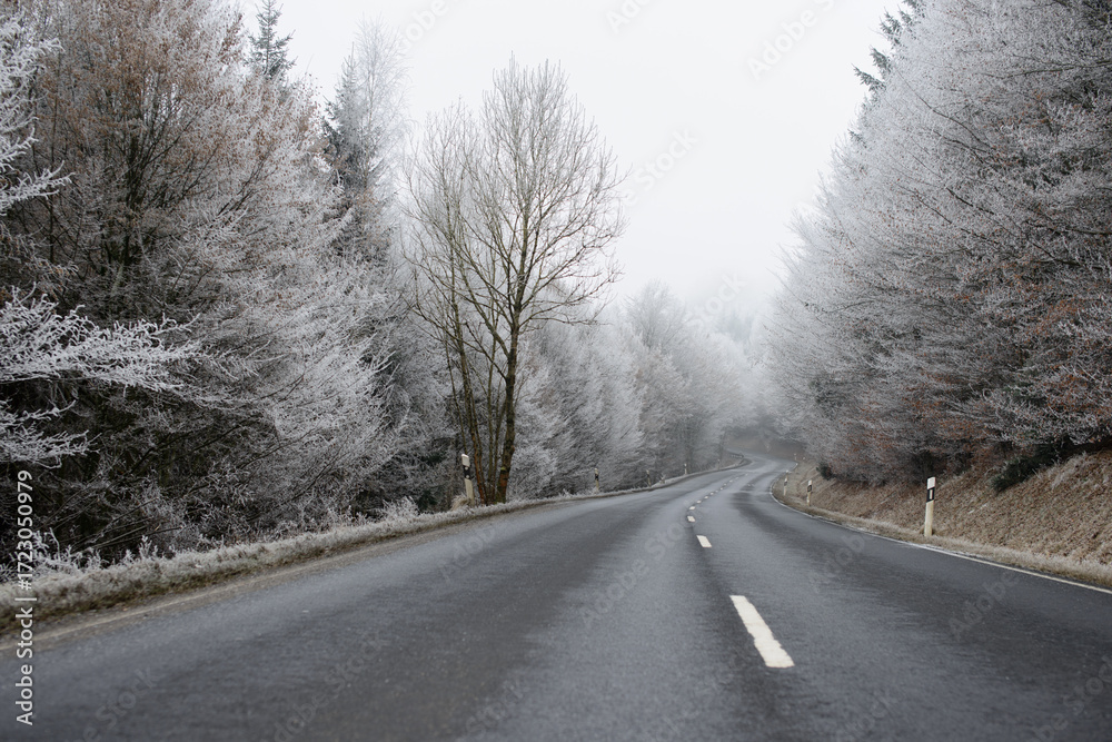 black ice - a street in the evening with the warning sign Stock Photo ...