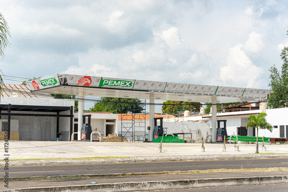 Pemex gas station with fuel pumps, green and red signs, service area ...