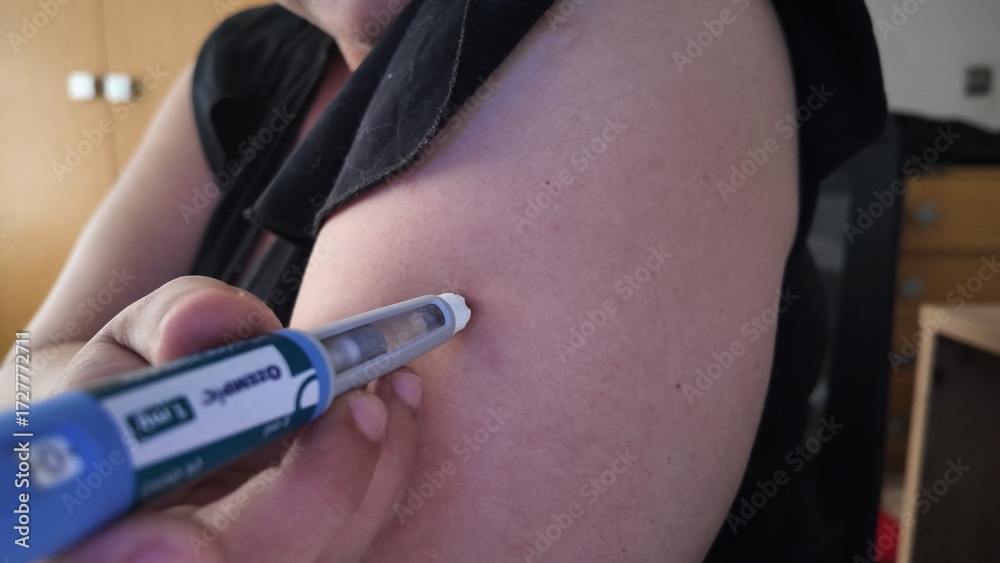 Ozempic Injection in progress, arm getting injected with medicine by a ...