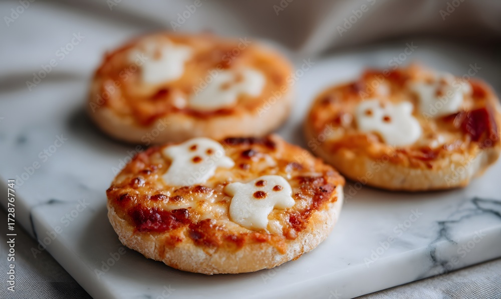 mini pizzas on a light marble table without a plate or decoration. The ...