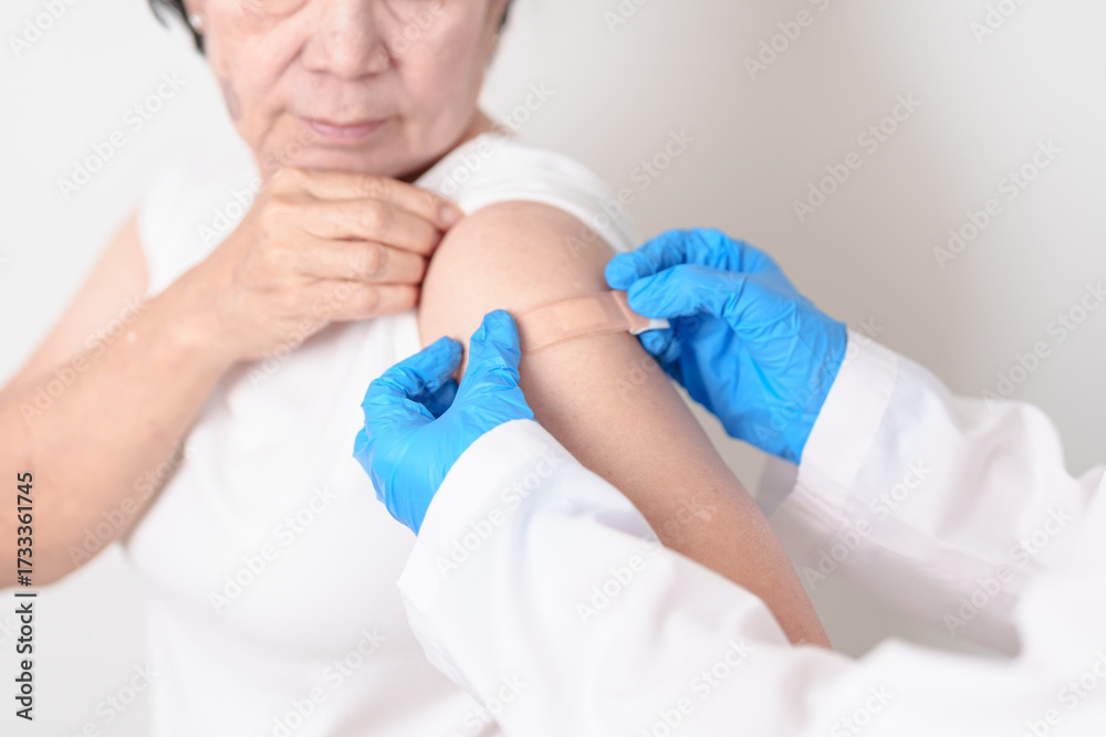 Elderly Woman with bandage after received vaccine. Vaccination and ...