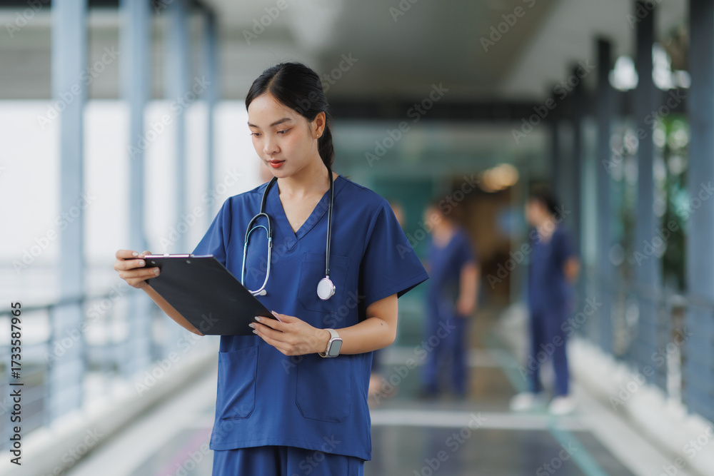 Focused doctor reading medical chart in hospital corridor Stock Photo ...