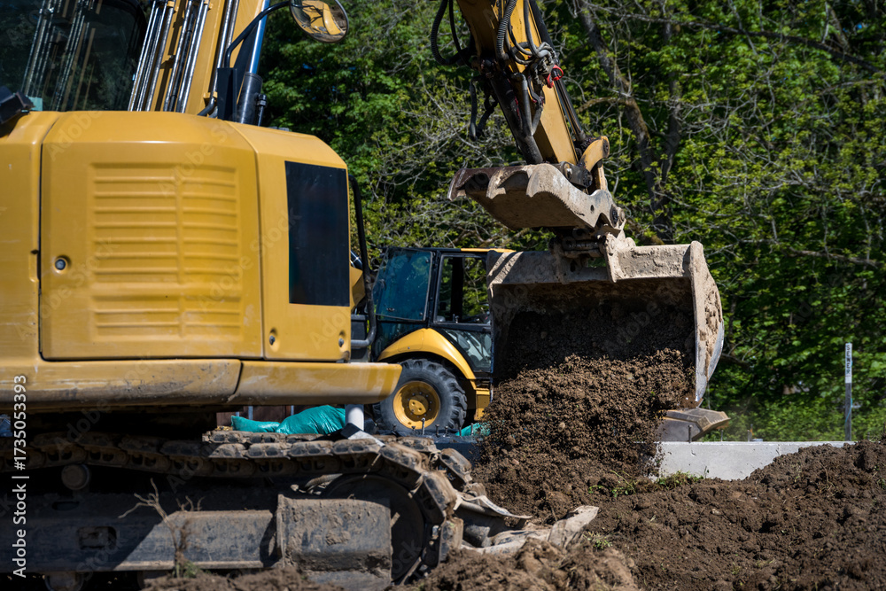 Workman using excavator, heavy construction equipment, to remove dirt ...