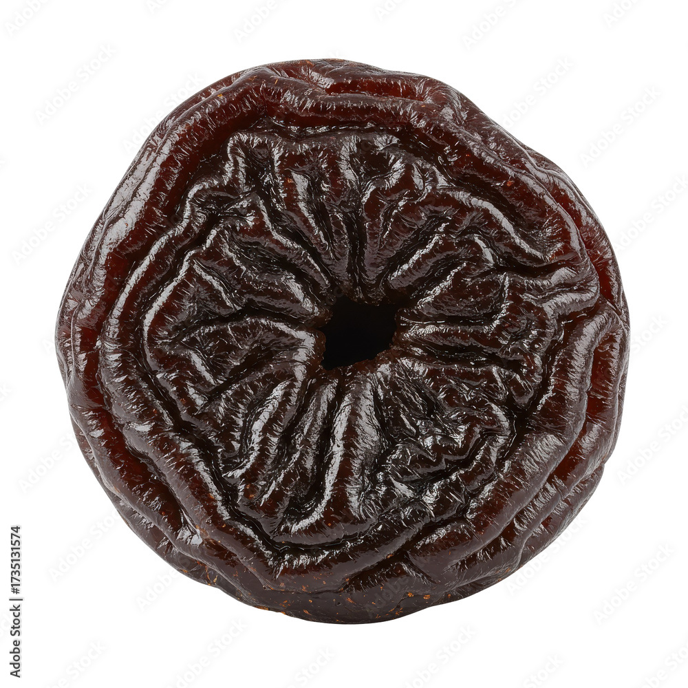 Wrinkled dried plum with a dark center, showing texture and detail ...