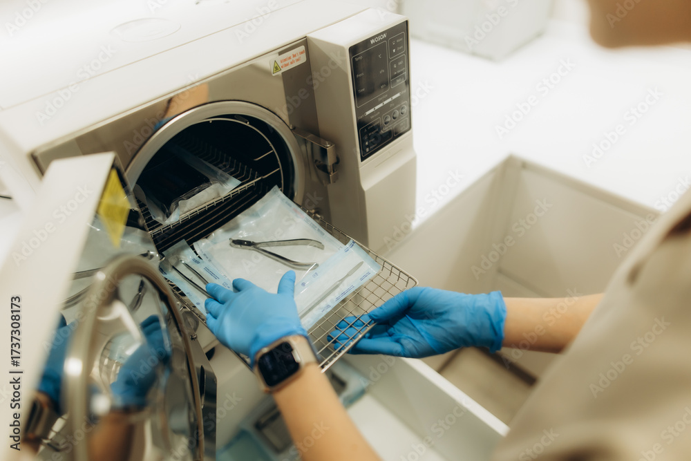 Nurse sterilizing surgical instruments inside autoclave in clinic Stock ...