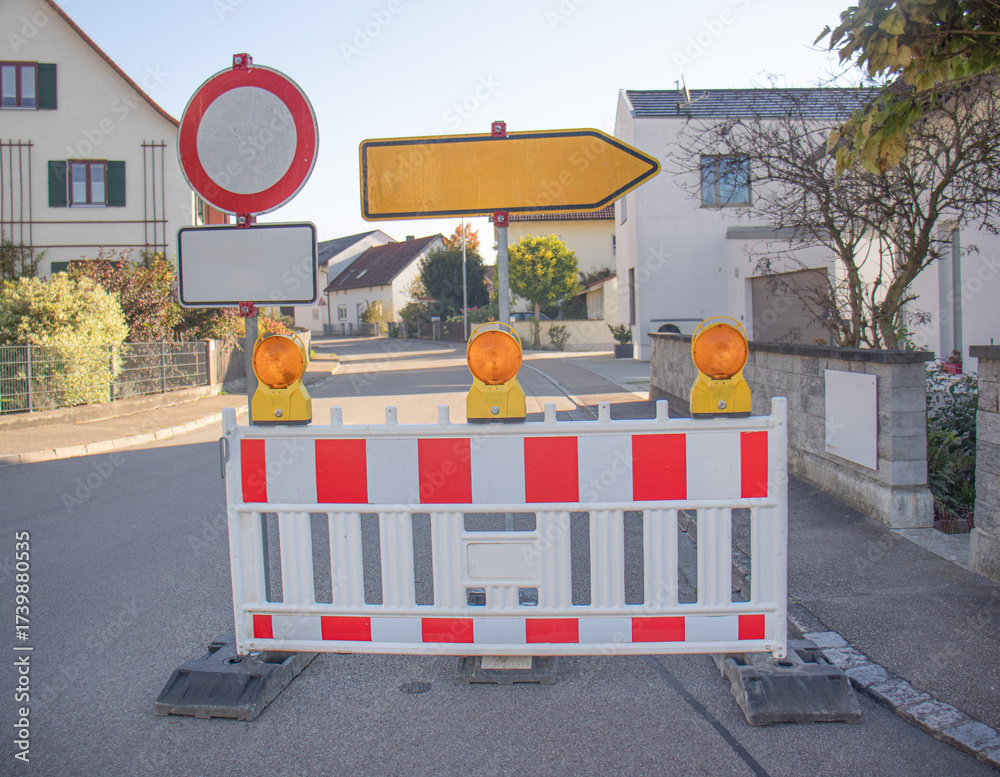 Road construction barrier with traffic signs and warning lights ...