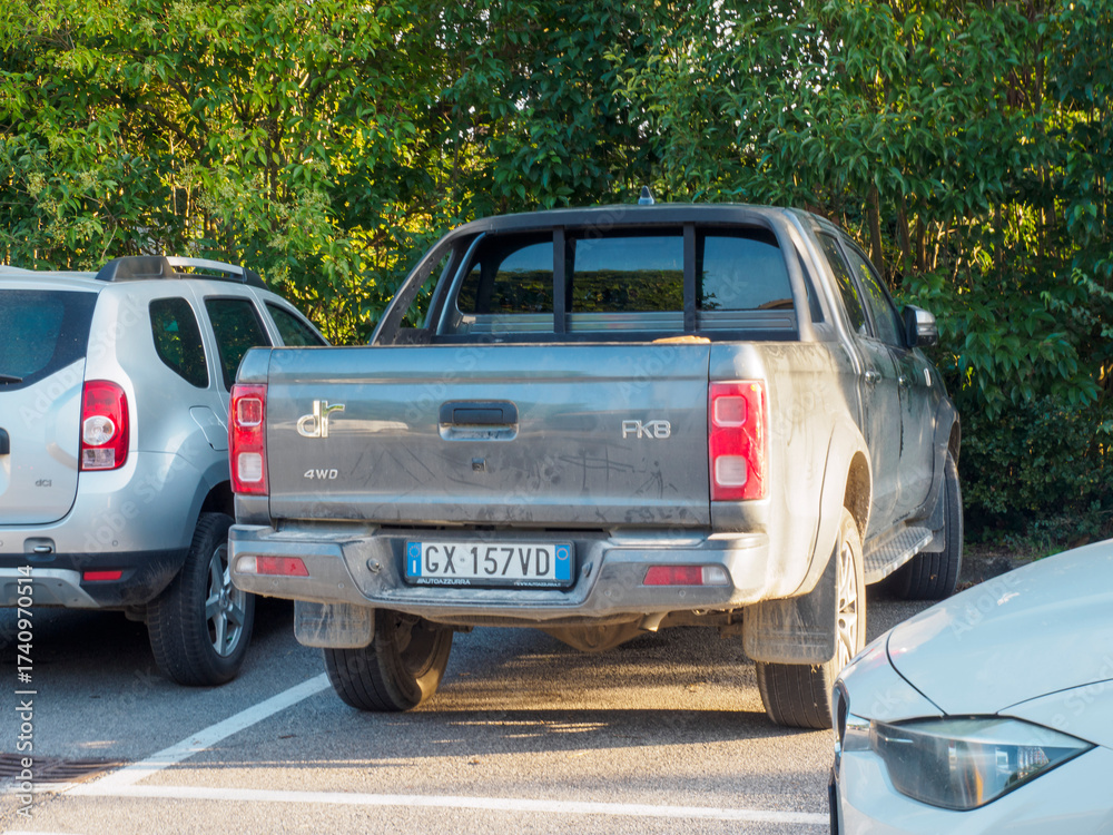 DR PK8 4WD dark grey pick up parked on urban asphalt, rear view with ...