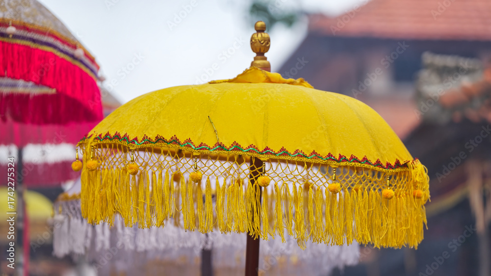 Yellow ceremonial balinese umbrella, known as tedung, hindu worship in ...