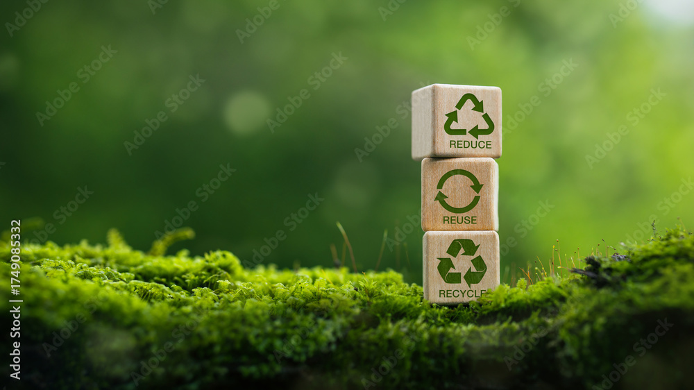 Recycle symbol on wooden blocks in green nature background. Eco concept ...