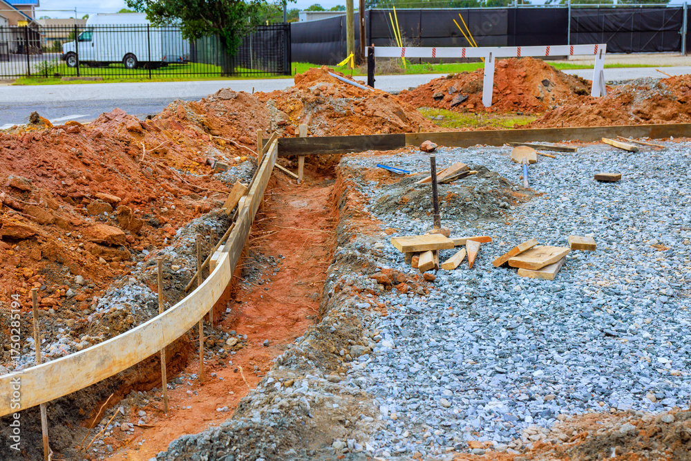 Workers prepare construction site with gravel wooden frameworks for new ...
