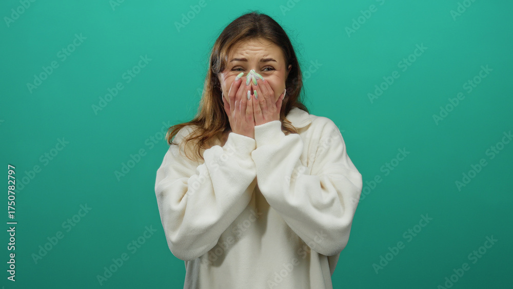 Young woman expressing emotions over isolated green background in ...