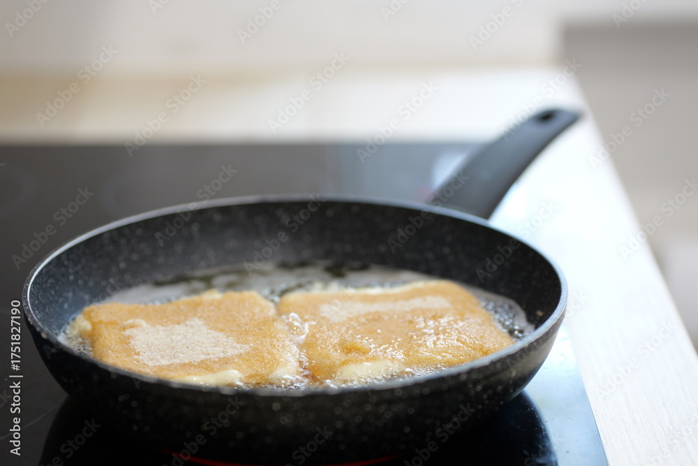 Frying food in a pan with oil. Close-up view of the cooking process ...