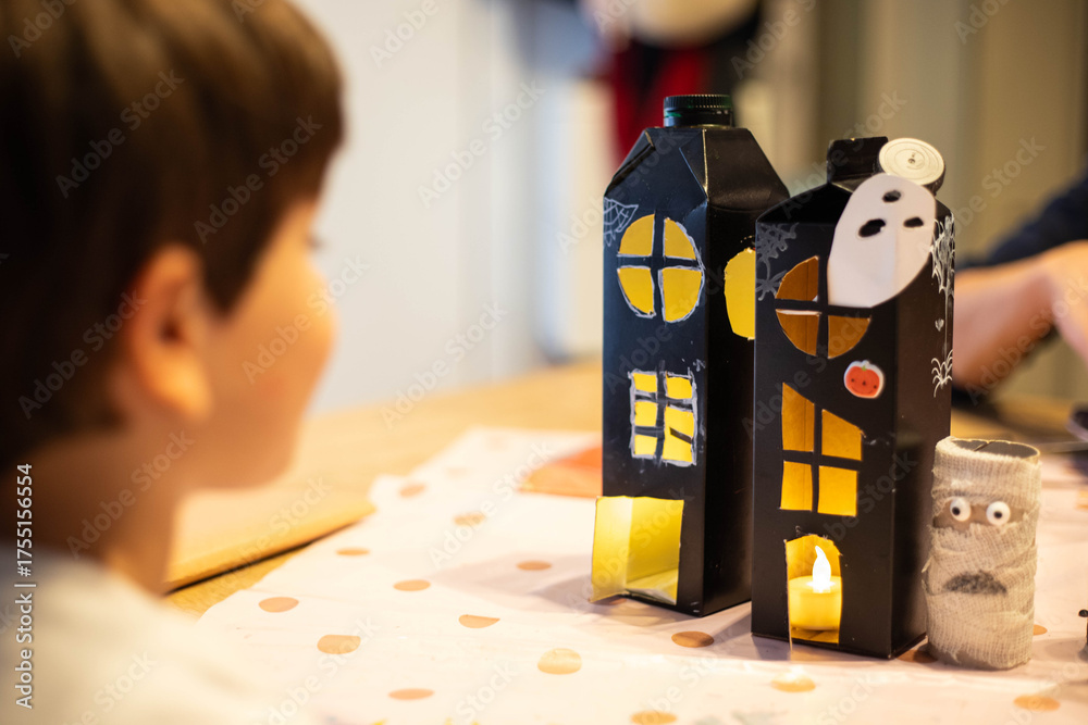 Stock-Foto „Child boy looking at black halloween haunted houses made ...