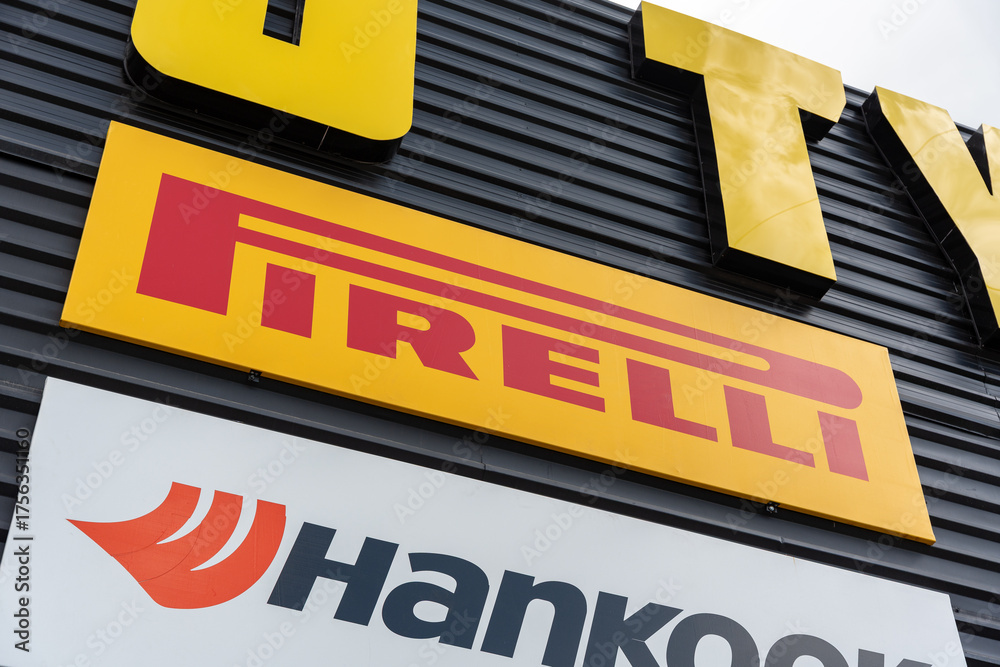 signs and logos of Pirelli and Hankook. Modern facade of a tire shop or ...