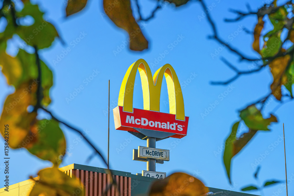 McDonald's logo, iconic golden arches above restaurant roof, autumn ...