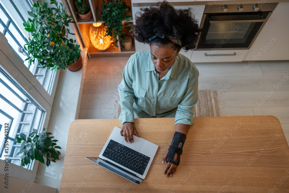 Top view African American woman wearing wrist brace for arm support ...