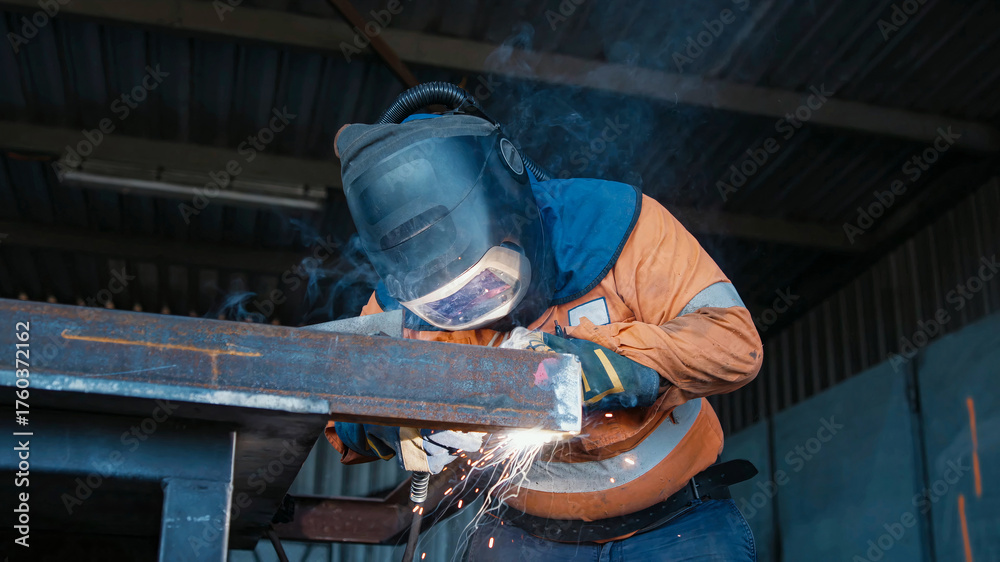 Welder operator in the process of constructing metal structures using ...