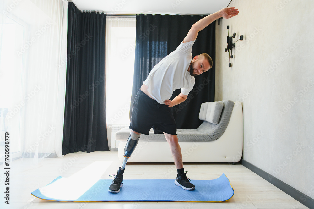 Full length portrait of man with prosthetic leg doing stretching ...
