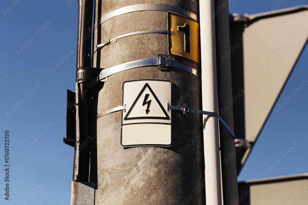 Photo Stock High voltage warning sign on metal pole with blue sky ...