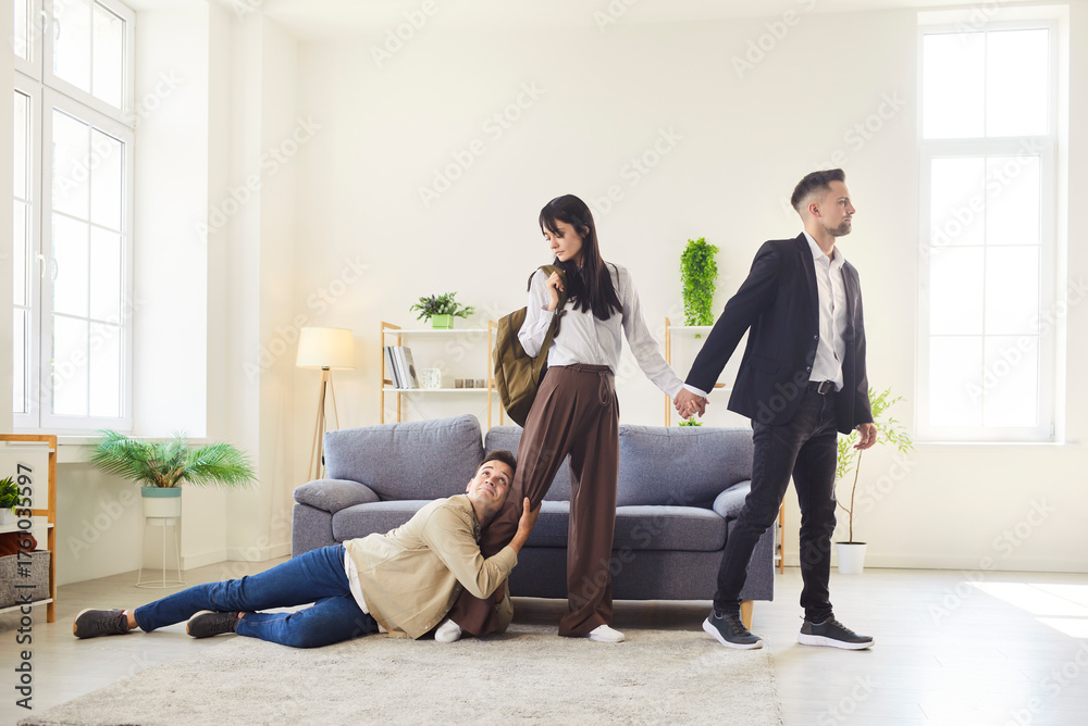 Desperate man holds woman leg as she walks away with another man ...
