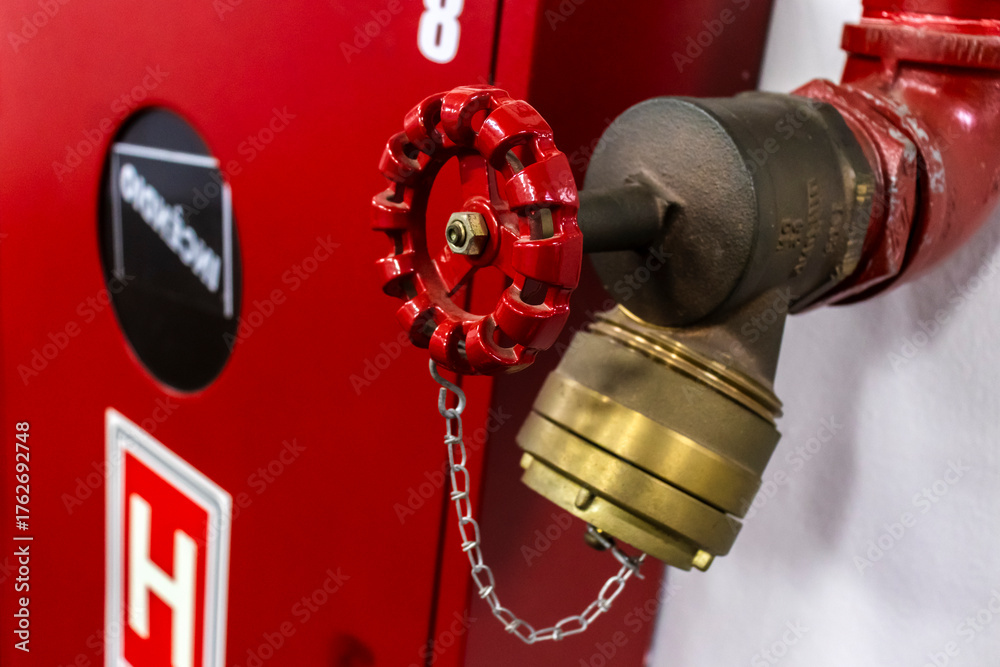 Close-up of a red fire hydrant valve and pipe connection. Part of an ...