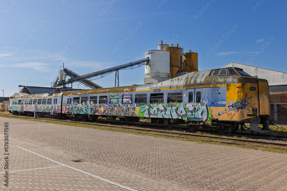 A derelict, graffiti-covered Dutch Koploper train (NS ICM) parked on a ...