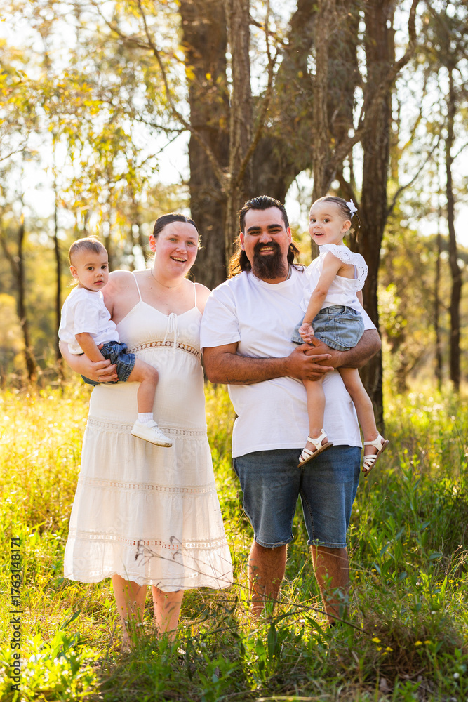 Portrait of Aboriginal dad with two kids and his wife together in ...
