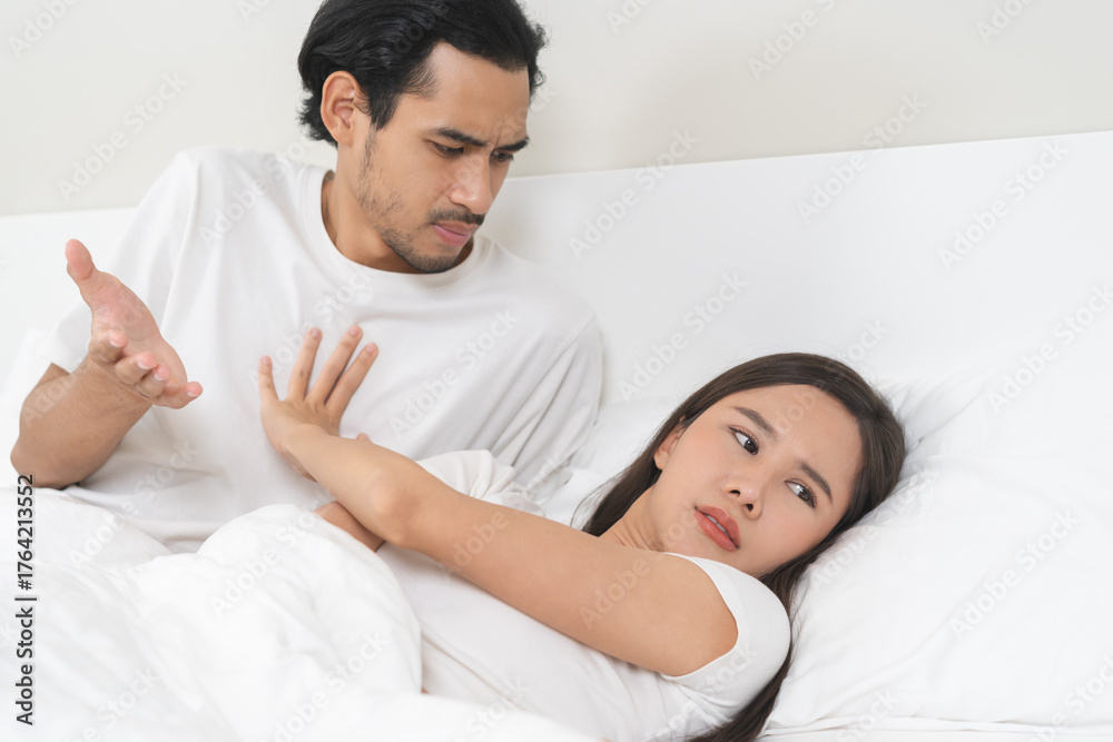 Angry, depressed, frustrated asian couple quarrel, fighting on bed in ...