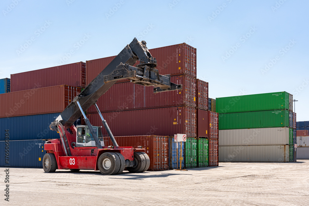 Reach stacker moving containers at a container yard in the port of ...