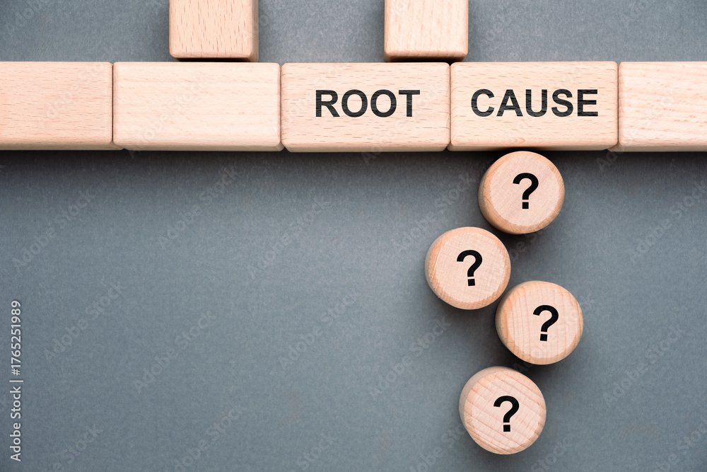 Wooden blocks arranged to show the phrase root cause with question mark ...