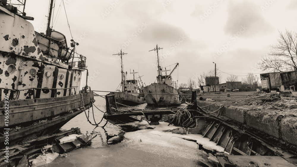 sunken and broken ships in a destroyed port in Ukraine during the war ...