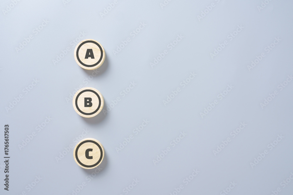 Wooden round blocks with letters A, B, and C arranged vertically on ...