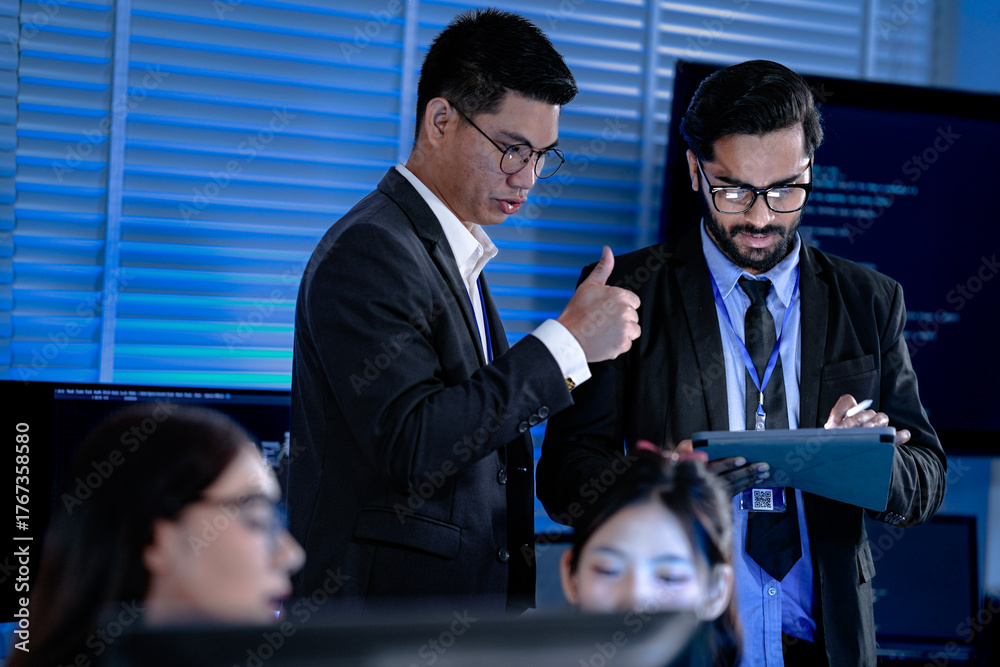 Lead developers analyze system architecture late night using tablet ...