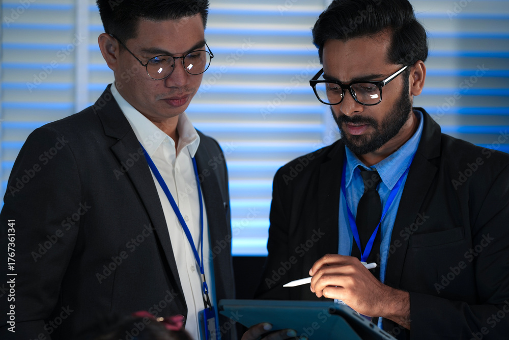 Lead developers analyze system architecture late night using tablet ...