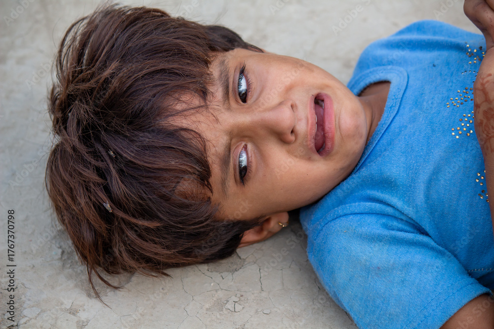 Poor Pakistani village girl crying on dusty ground, sad child ...