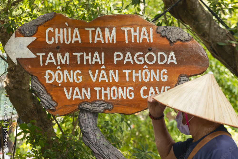 Wooden sign showing direction to the Tam Thai Pagoda and Van Thong cave ...