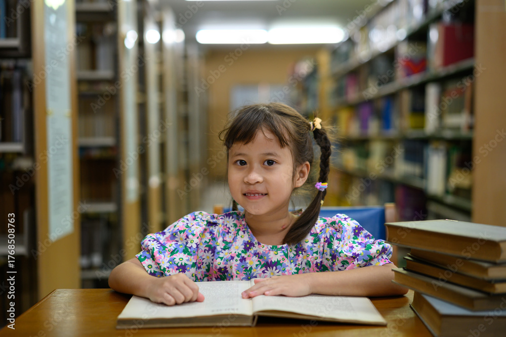 Photo set of Little girl reading aloud from exercise book with joy in ...