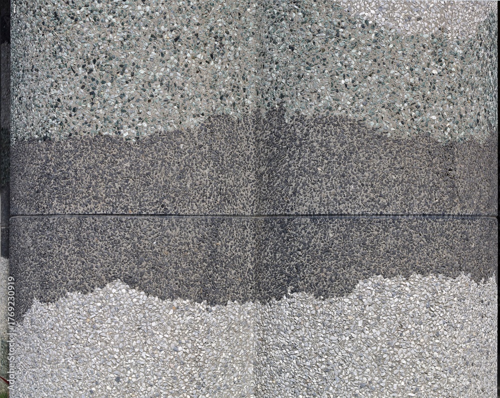 Concrete aggregate wall with bands of three colors: black, gray and ...