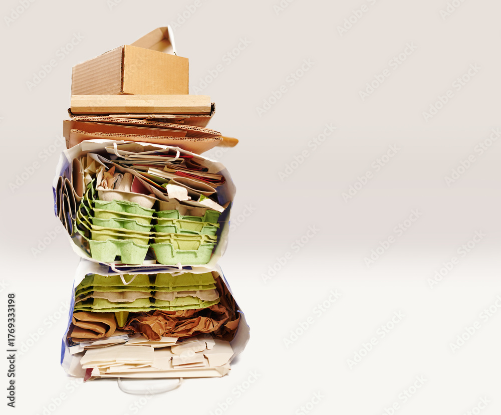 Sorting garbage for recycling on beige background. Cardboard waste ...