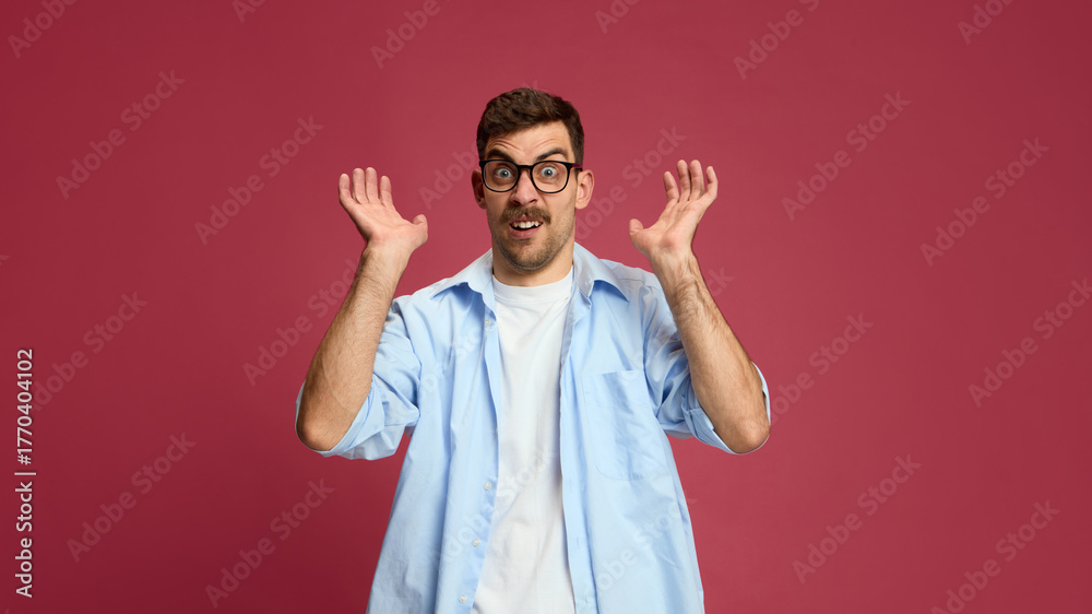 Surprised man raising hands in disbelief expressing shock and curiosity ...