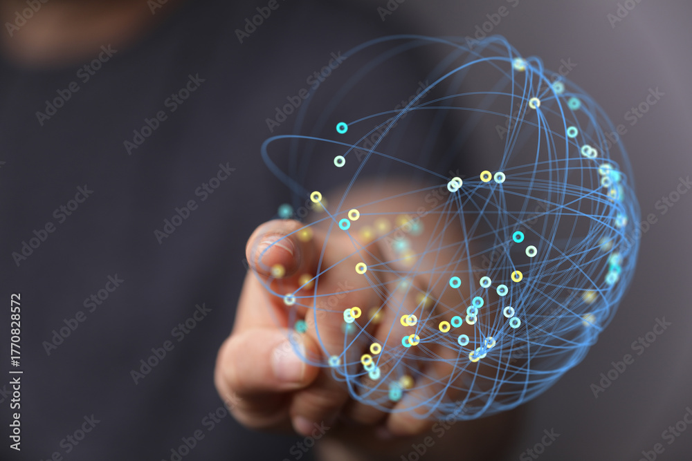 Abstract image showing a hand touching a digital sphere with connected ...